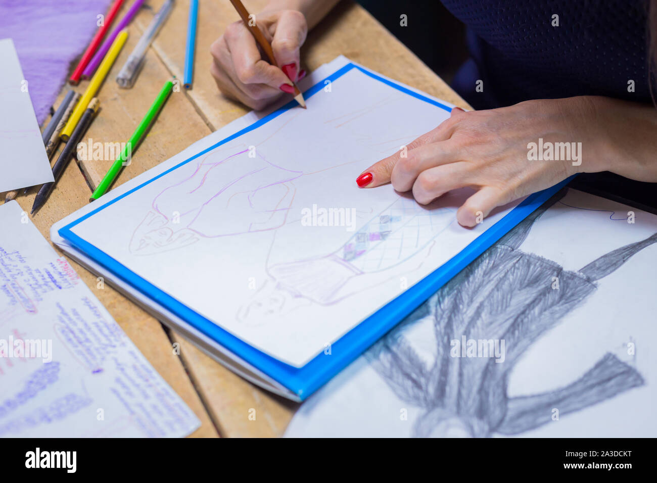 Fashion designer drawing design sketch Stock Photo - Alamy
