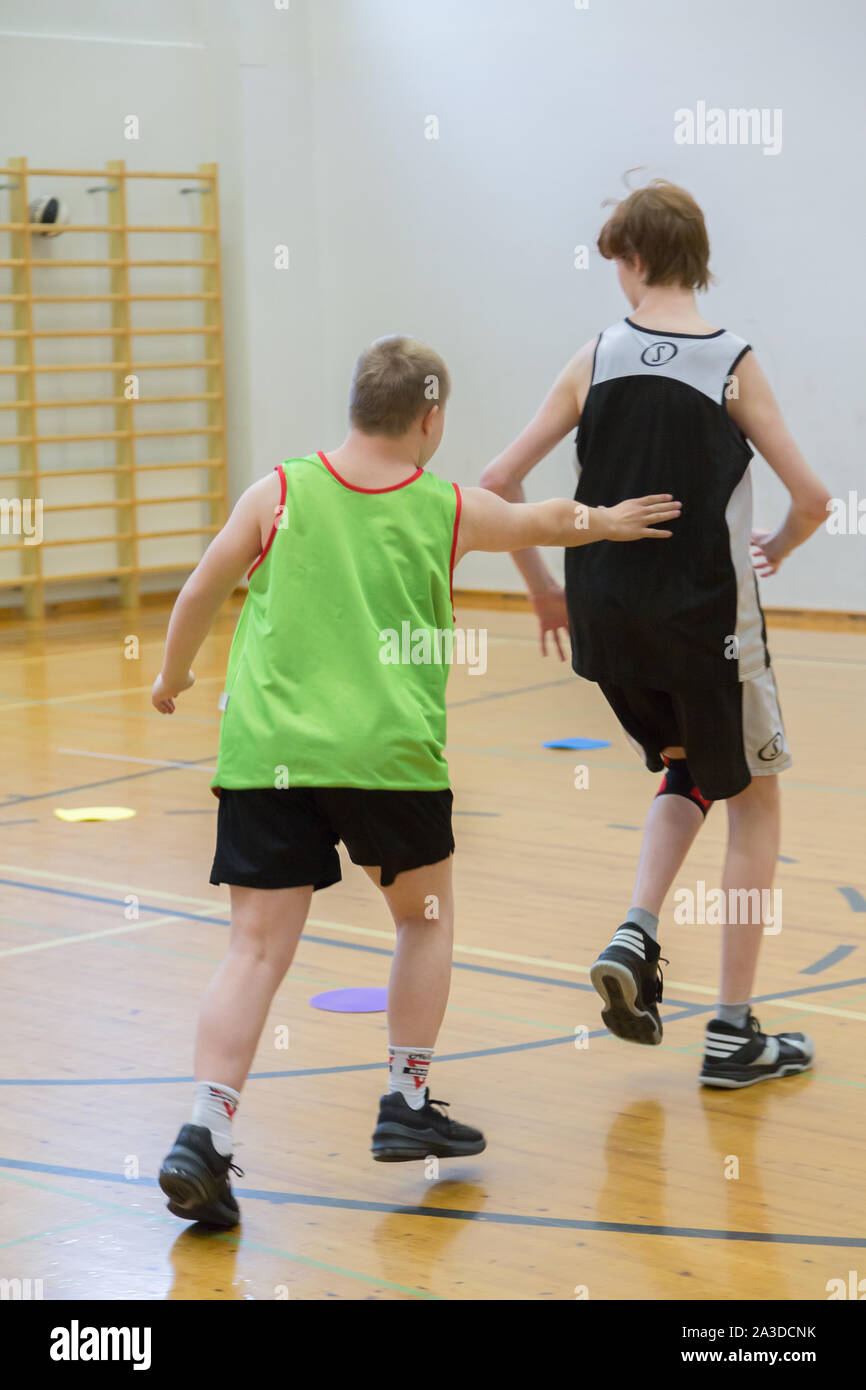 Group of disabled down syndrome men and women doing sports at indoor ...