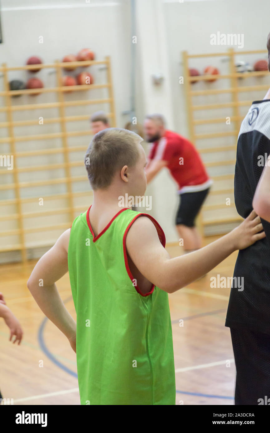 Group of disabled down syndrome men and women doing sports at indoor ...
