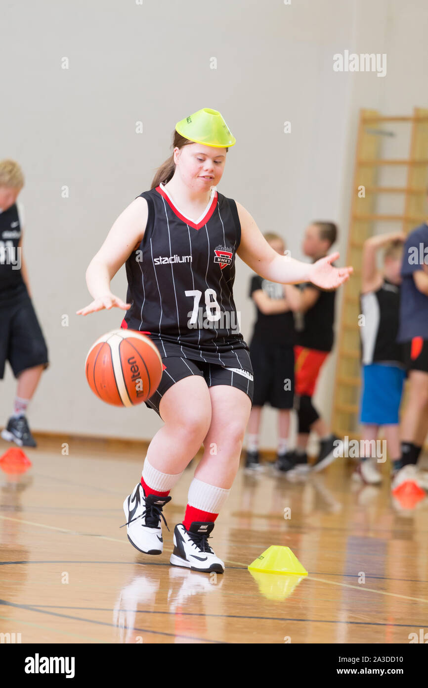 Group of disabled down syndrome men and women doing sports at indoor ...