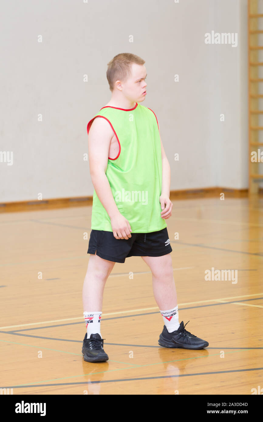 Group of disabled down syndrome men and women doing sports at indoor ...