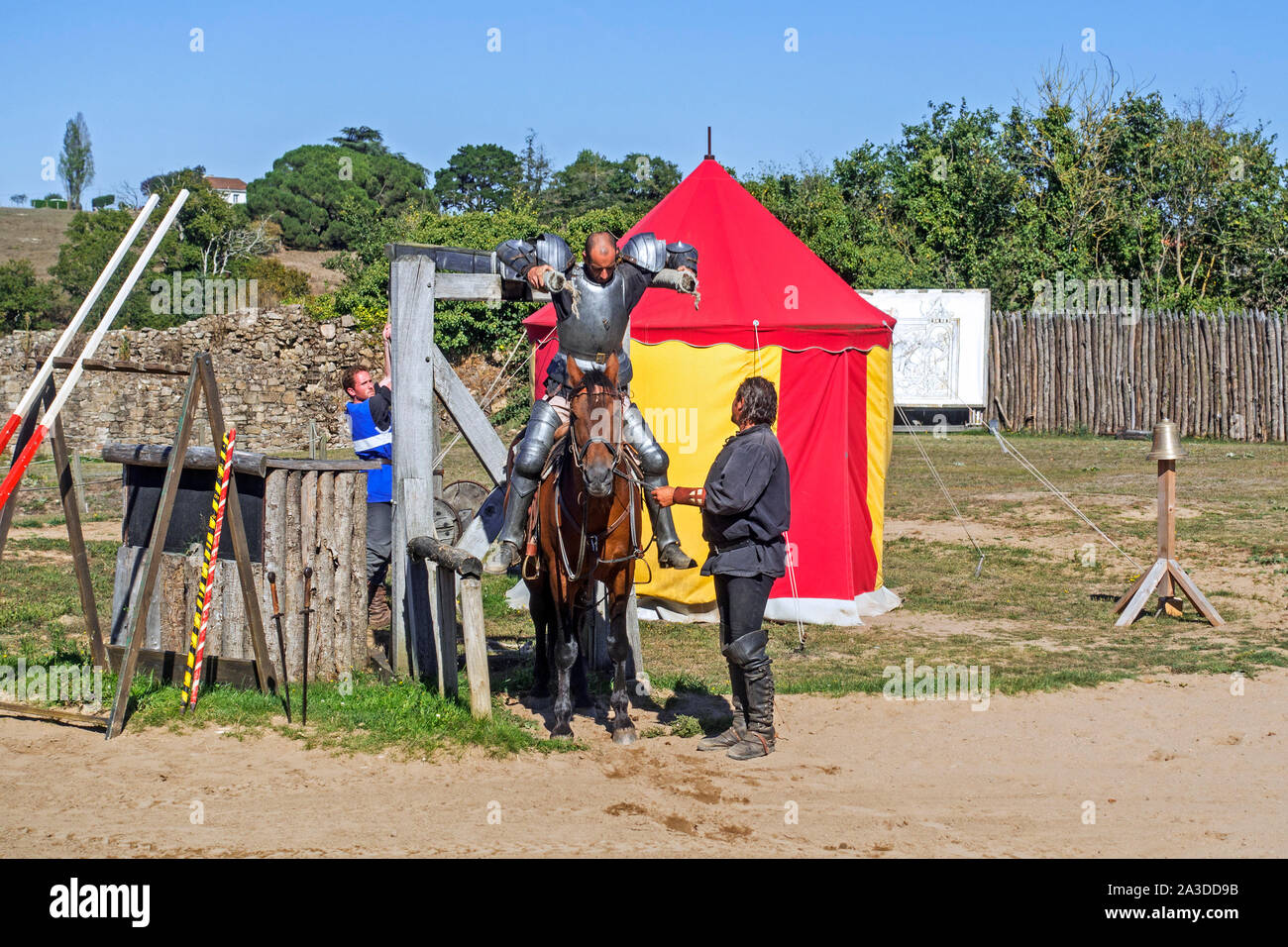 Medieval knight in suit of armour lifted with wooden lever to mount his ...