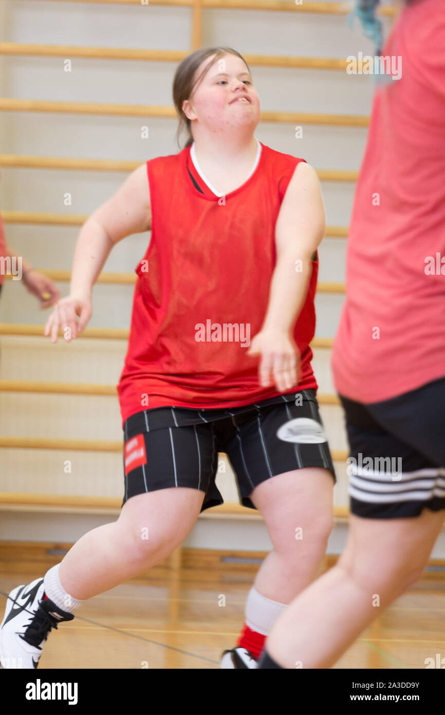 Group of disabled down syndrome men and women doing sports at indoor ...