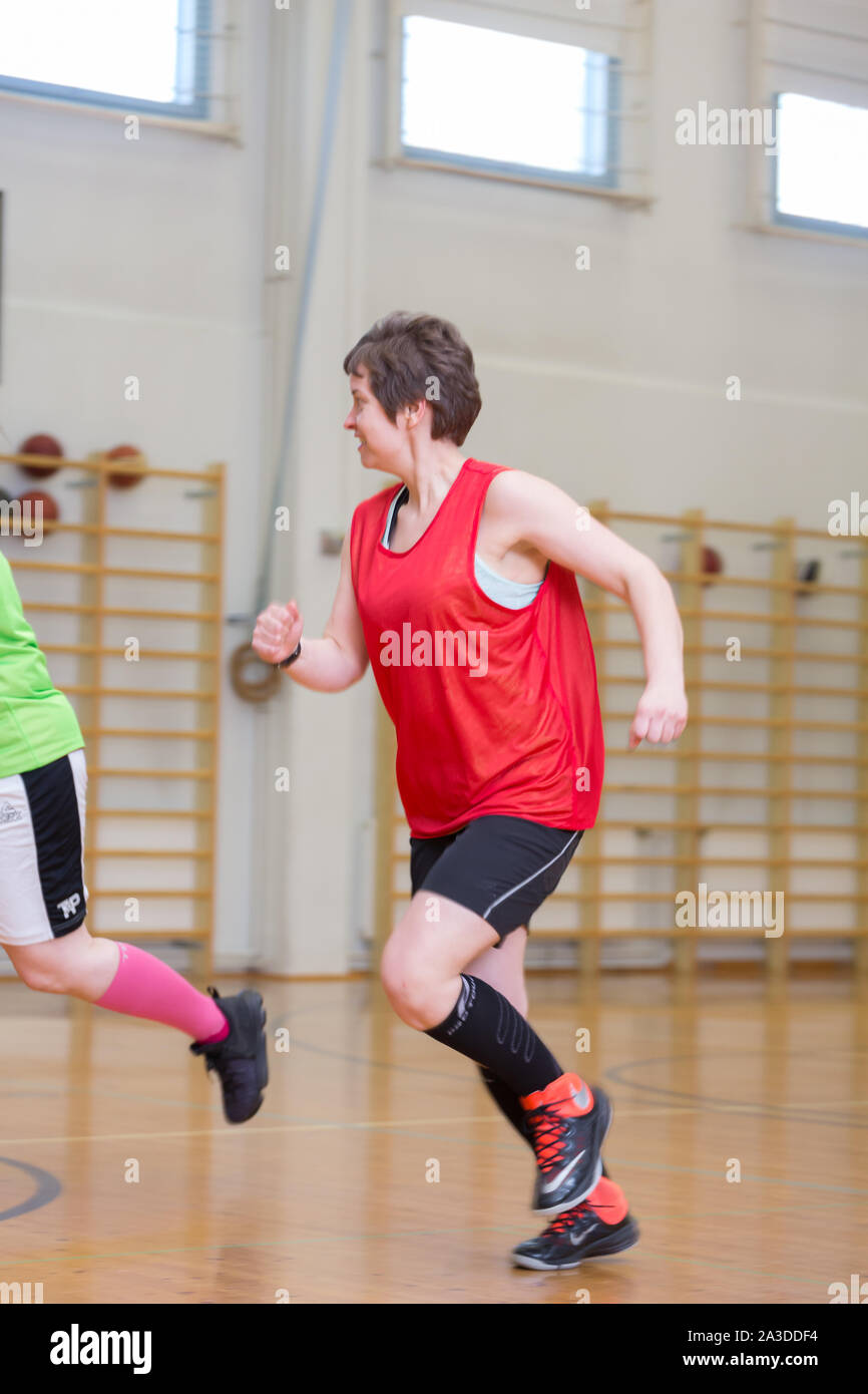 Group of disabled down syndrome men and women doing sports at indoor ...