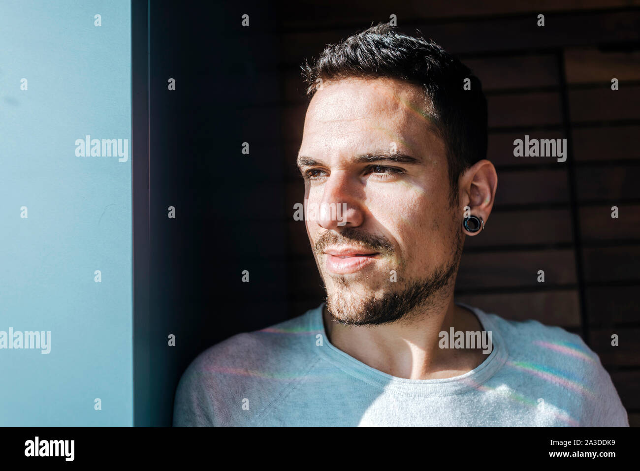 Handsome hispanic man at home looking to side, relax profile pose Stock ...