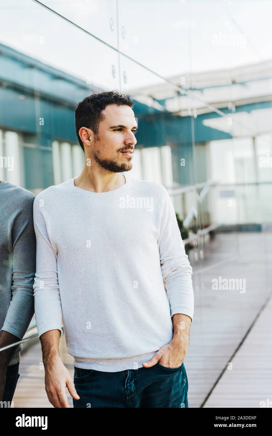 One attractive man leaning on glass shop window looking away Stock ...