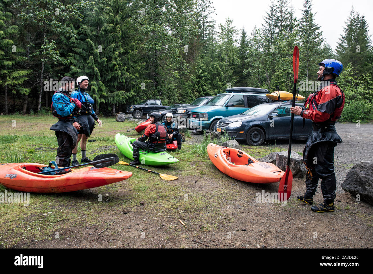 A group of whitewater kayakers hang out after paddling the Cheakamus ...