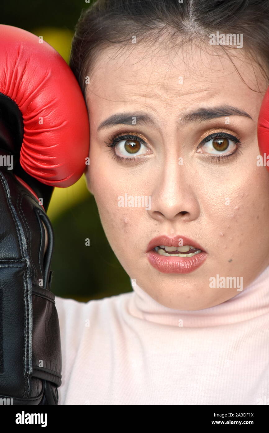 Confused Female Boxer Wearing Boxing Gloves Stock Photo - Alamy