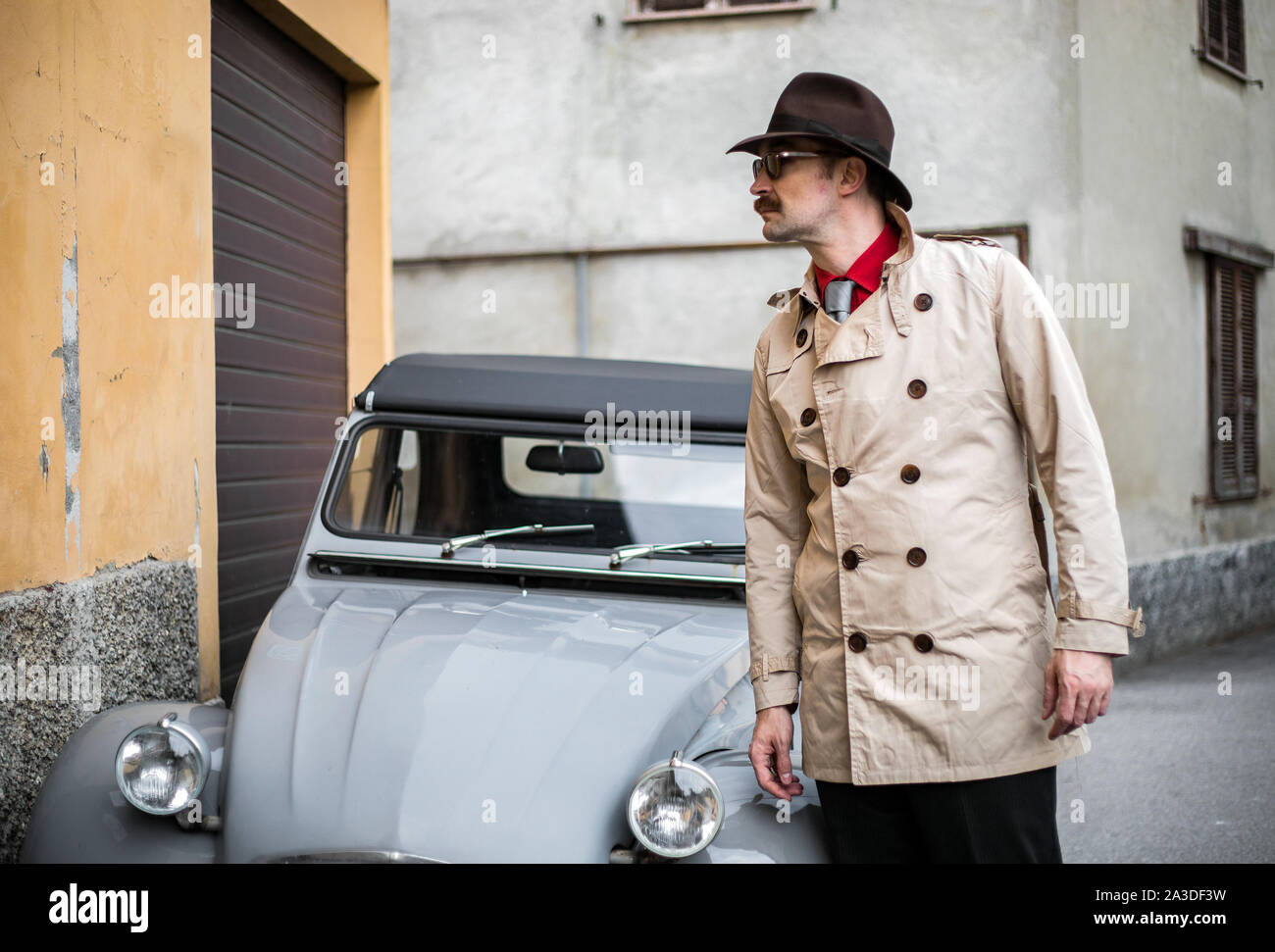 Detective walking in the city slums Stock Photo - Alamy