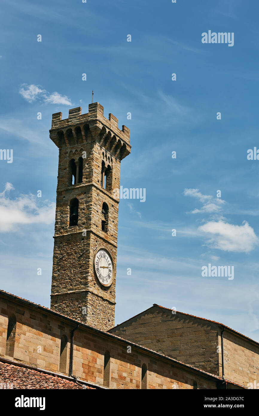 Low angle of ancient stone building tower with clock in European city ...