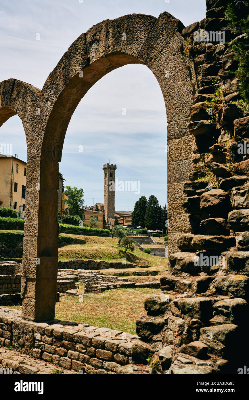 Brick old construction on grassy lawn with building of ancient Italian ...