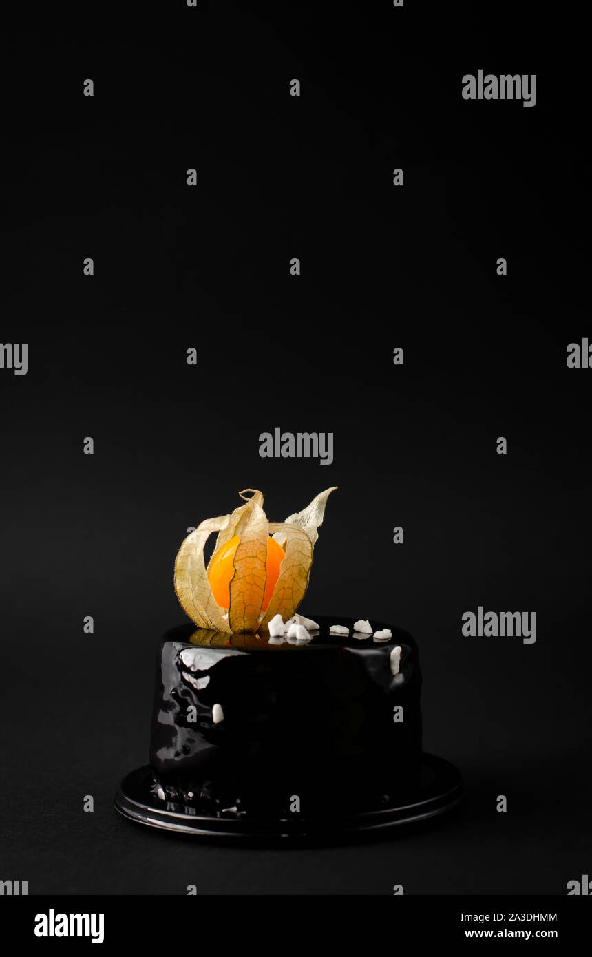 Organic Deep Dark Chocolate Cake decorated with physalis on black ...