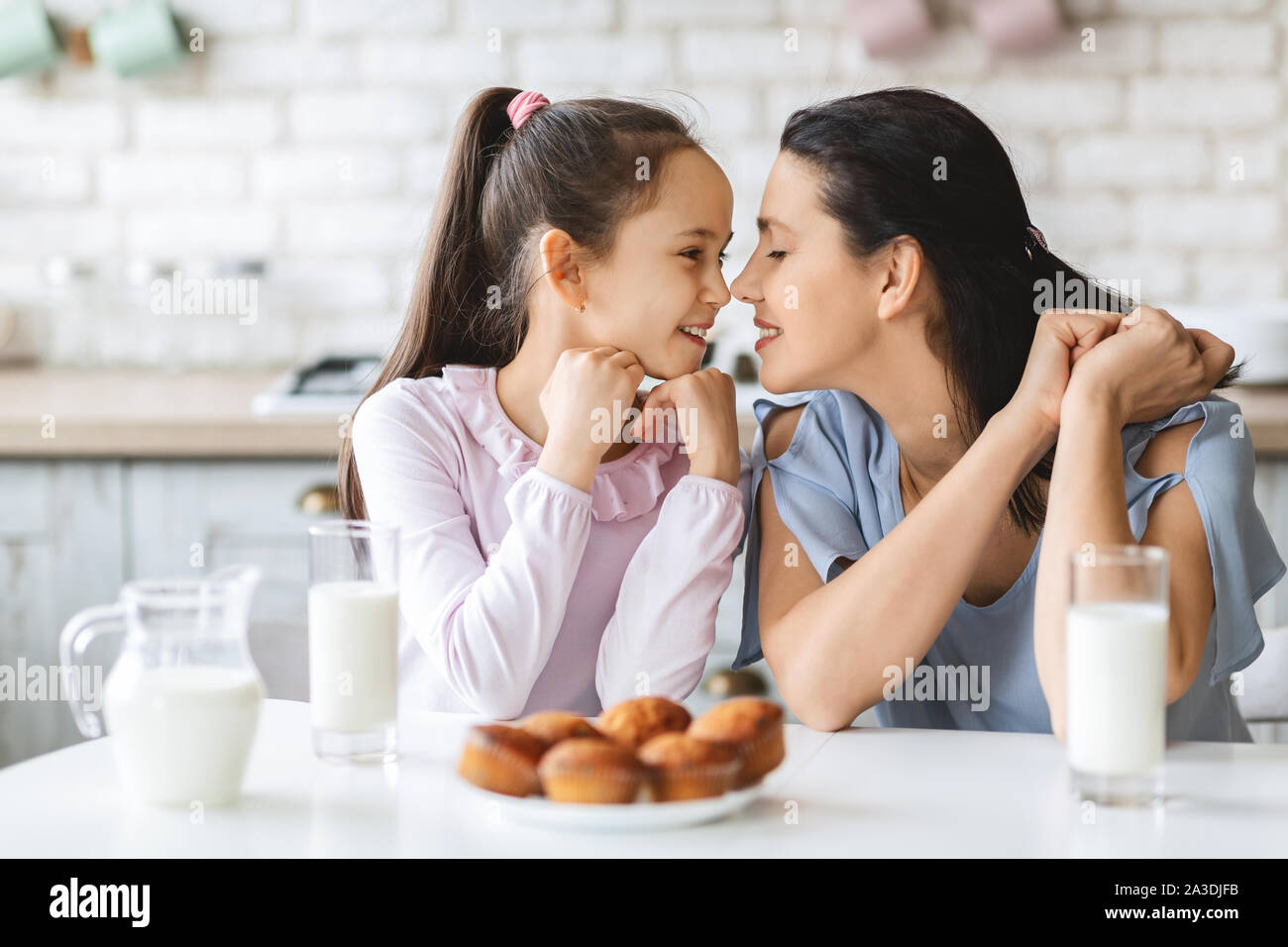 Mother and daughter touching noses and smiling to each other Stock ...