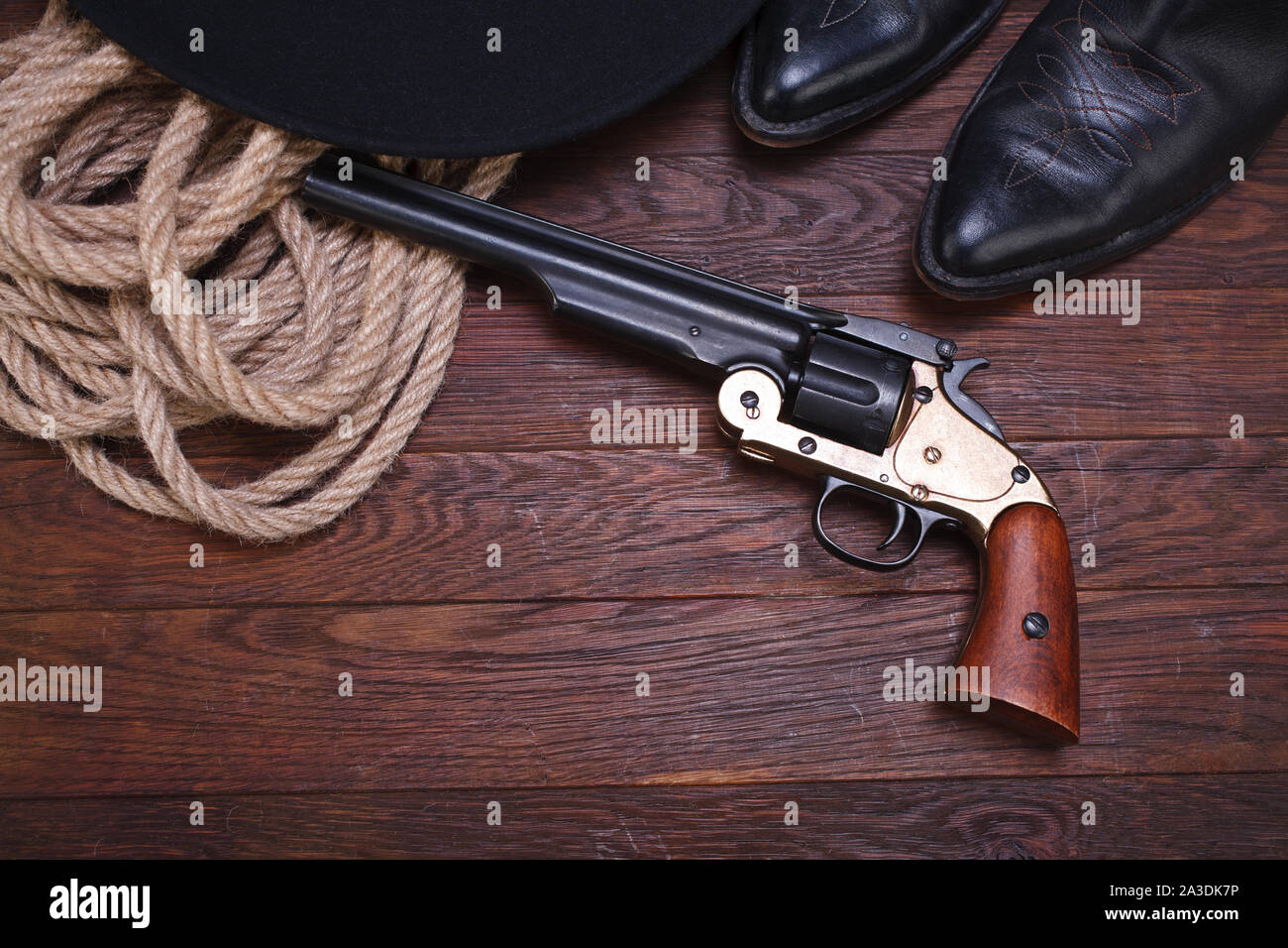 Old western gun with hat, rope and boots Stock Photo - Alamy