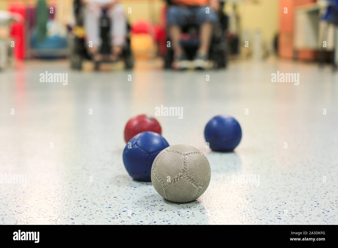Disabled Boccia players training on a wheelchair. Close up of little ...
