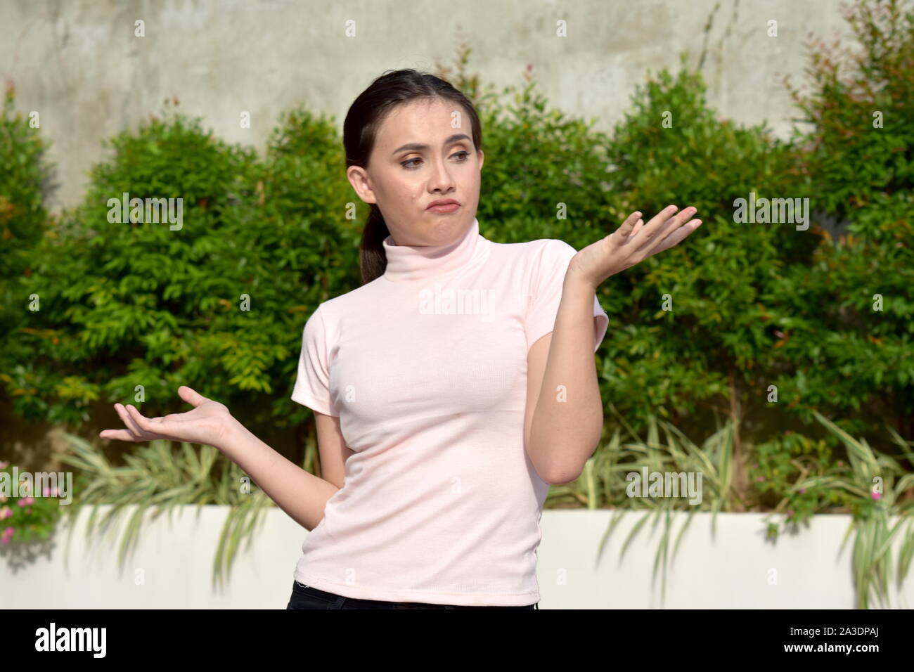 An Undecided Pretty Female Woman Stock Photo - Alamy