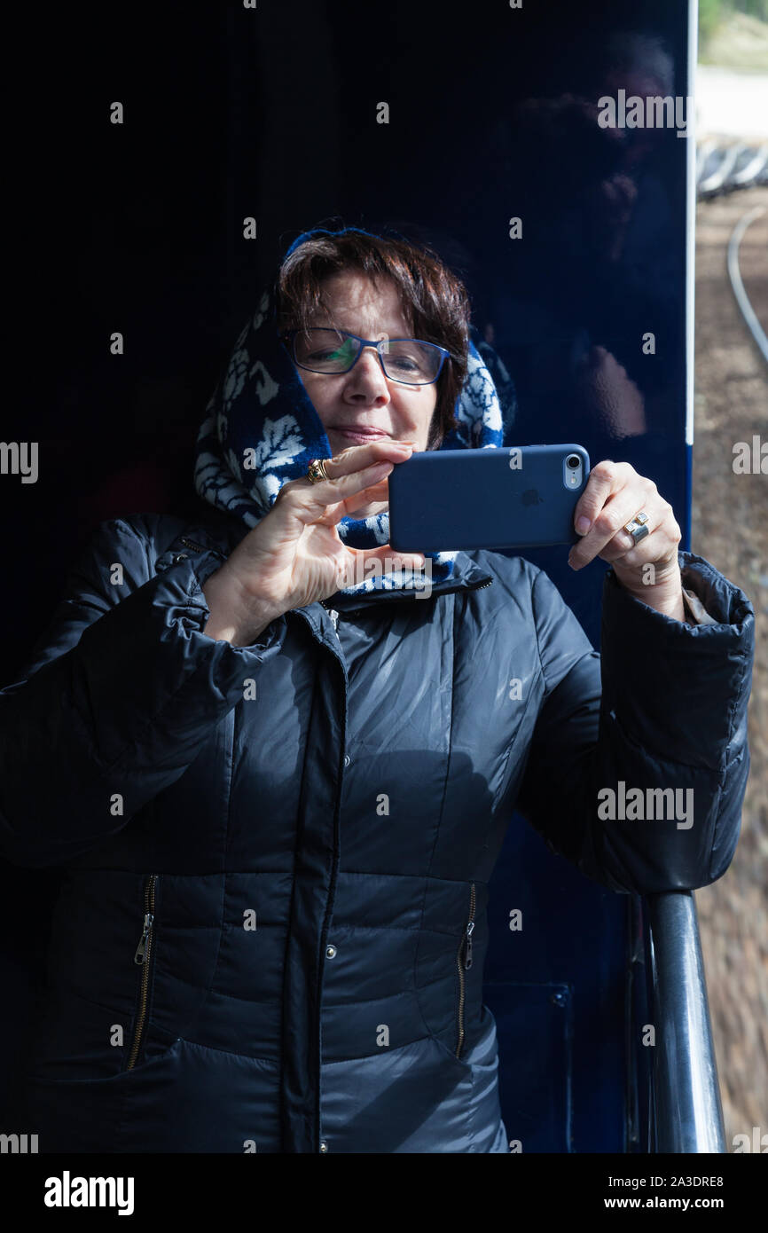 Female passenger taking a photograph from the observation deck of the ...