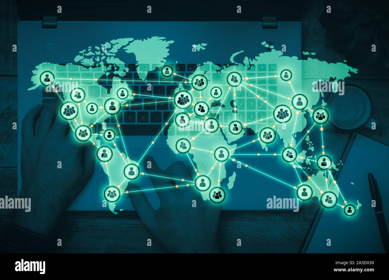 Worldwide digital communication network with top view of someone typing ...