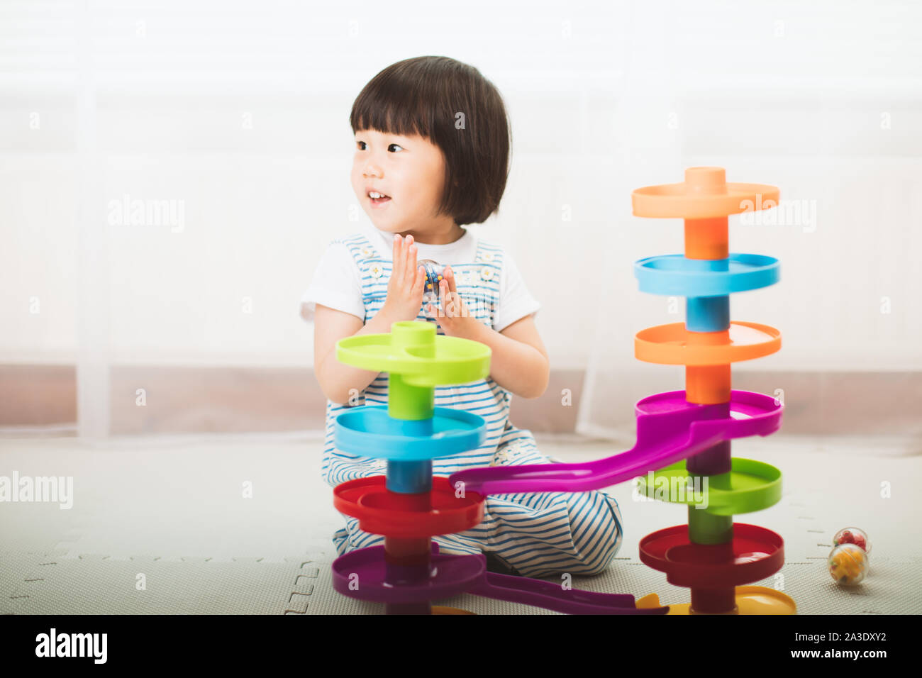 toddler girl play stack ball game at home Stock Photo - Alamy