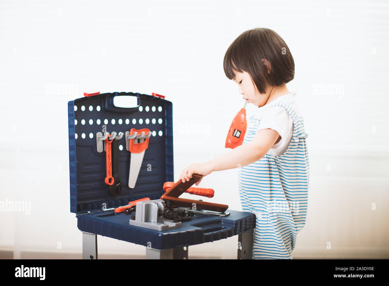 toddler baby girl pretend play DIY tools Stock Photo - Alamy