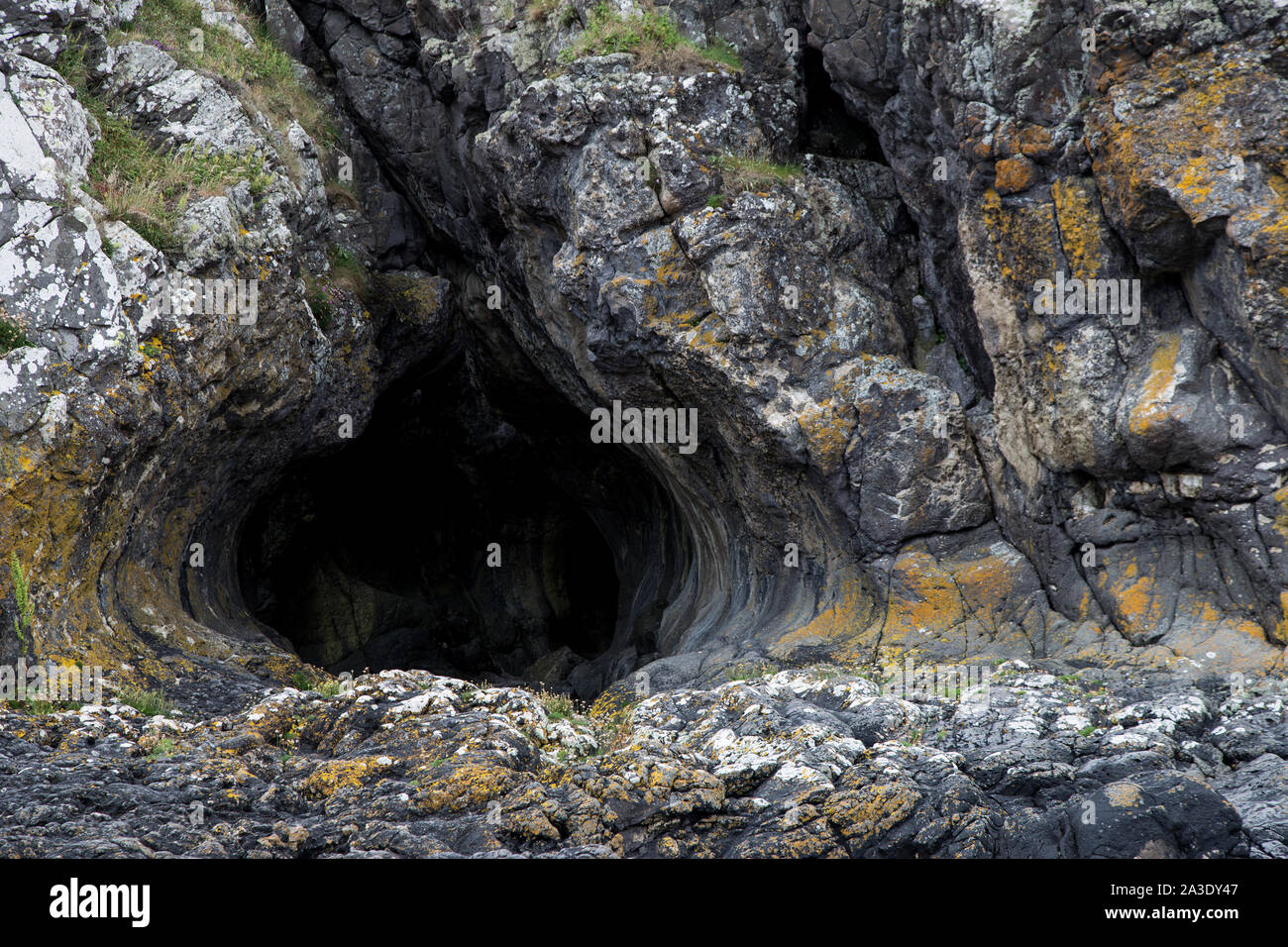 Rock face cave at a coastal location in Scotland Stock Photo - Alamy