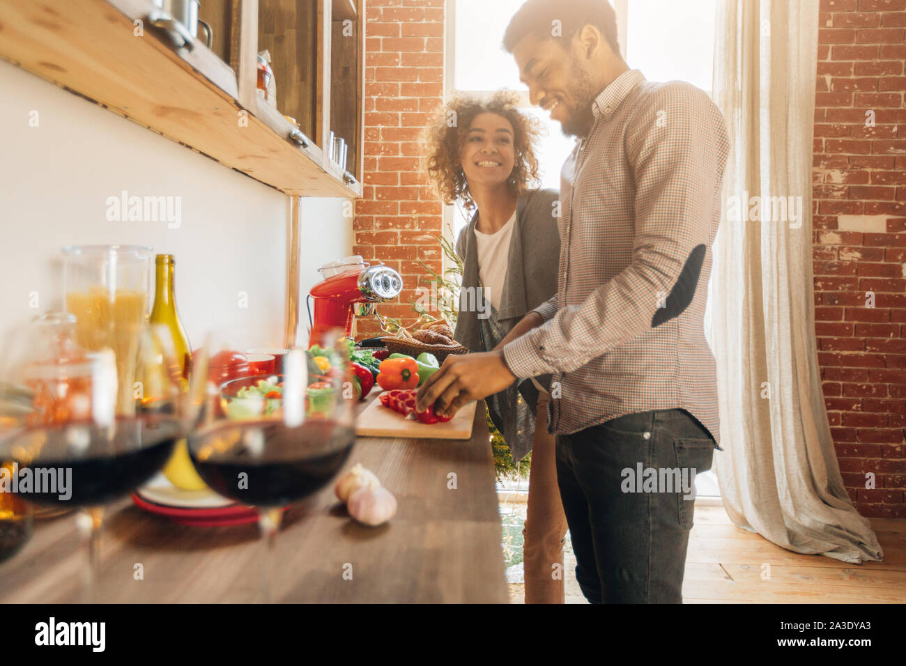 Happy couple cooking together Stock Photo - Alamy