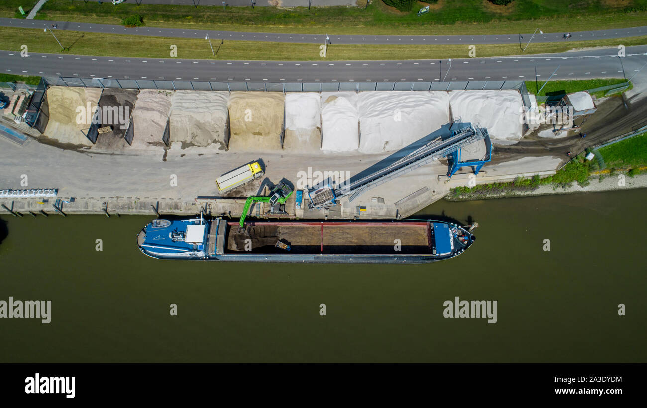 Loading barge with sand and rubble on a small berth. Freight transport ...