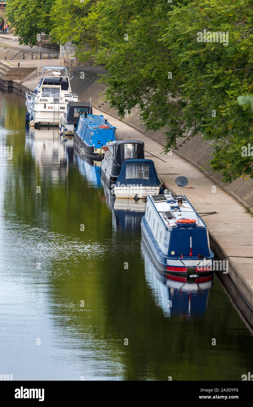 pleasure boats and canal river narrow boats and barges on the river ...