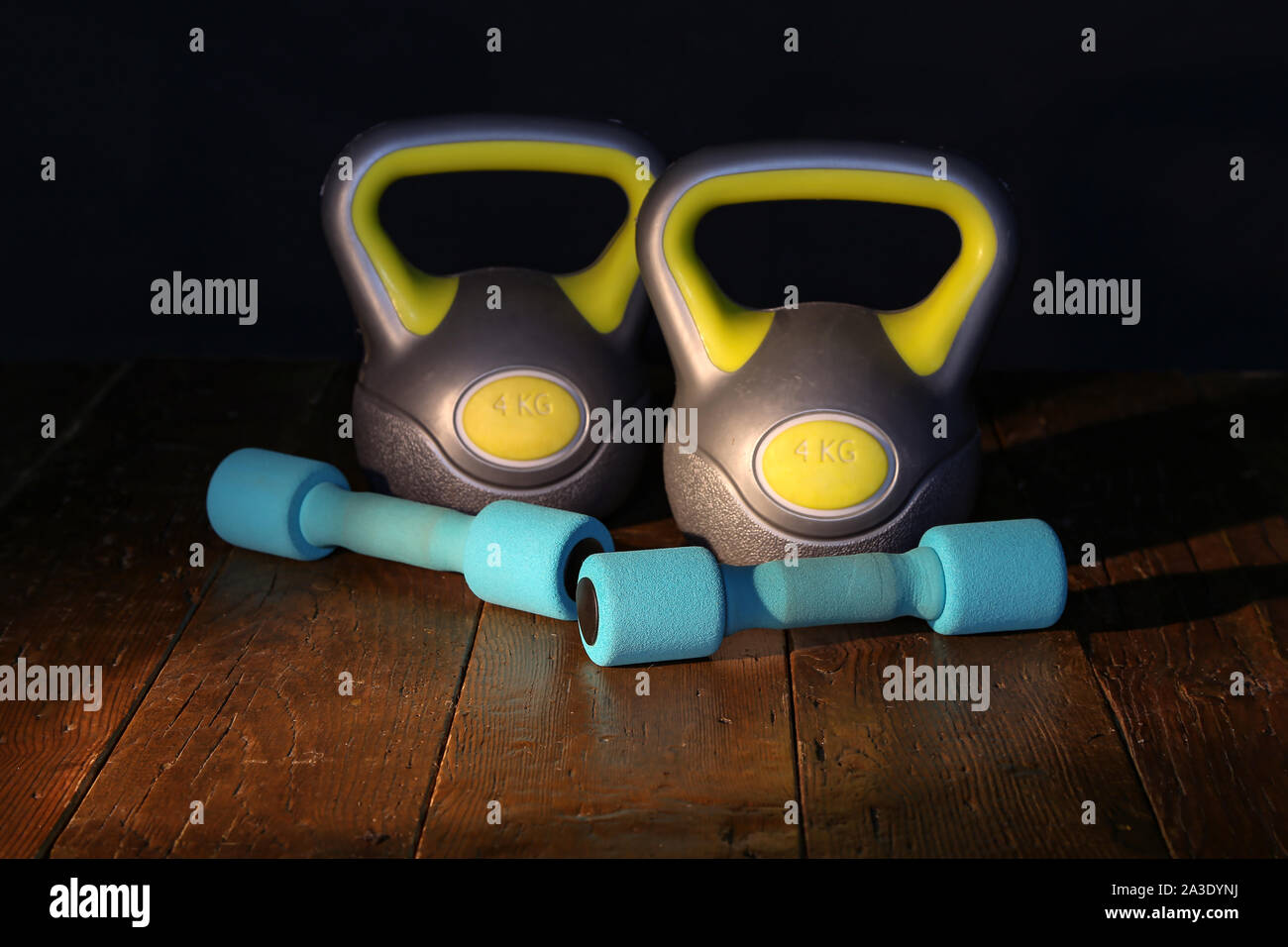 Multi-colored weights and dumbbells at the fitness center Stock Photo ...