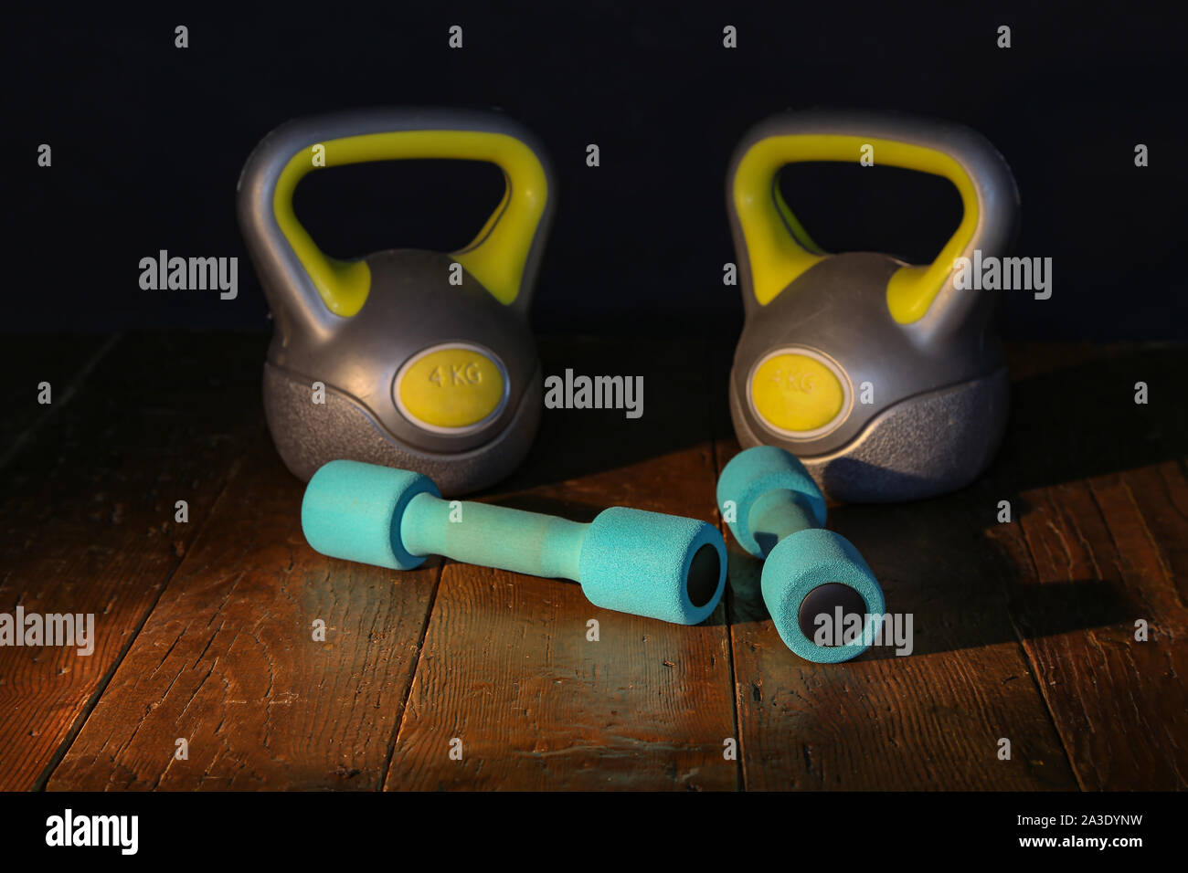 Multi-colored weights and dumbbells at the fitness center Stock Photo ...
