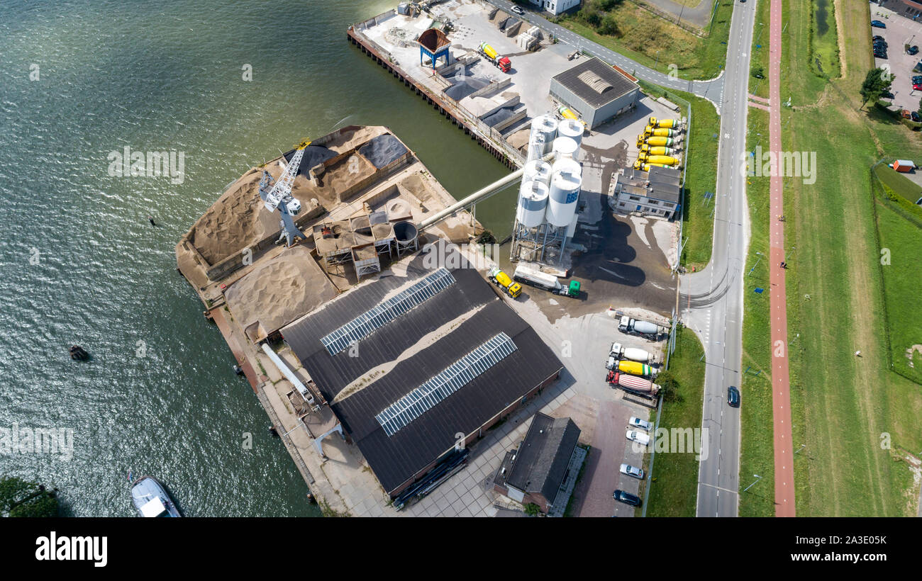 Loading barge with sand and rubble on a small berth. Freight transport ...