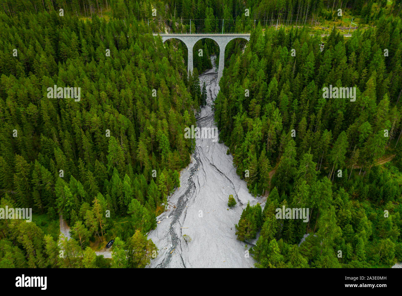 Inn River flowing in the forest in Switzerland. Aerial view from drone ...