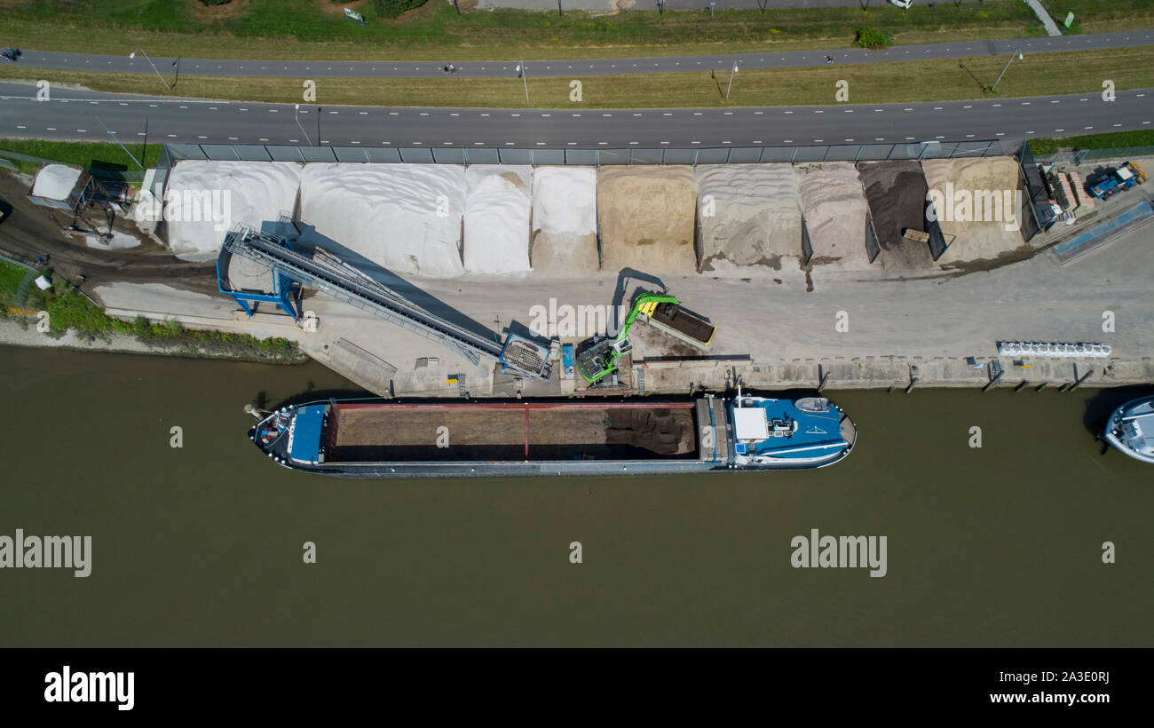 Loading barge with sand and rubble on a small berth. Freight transport ...
