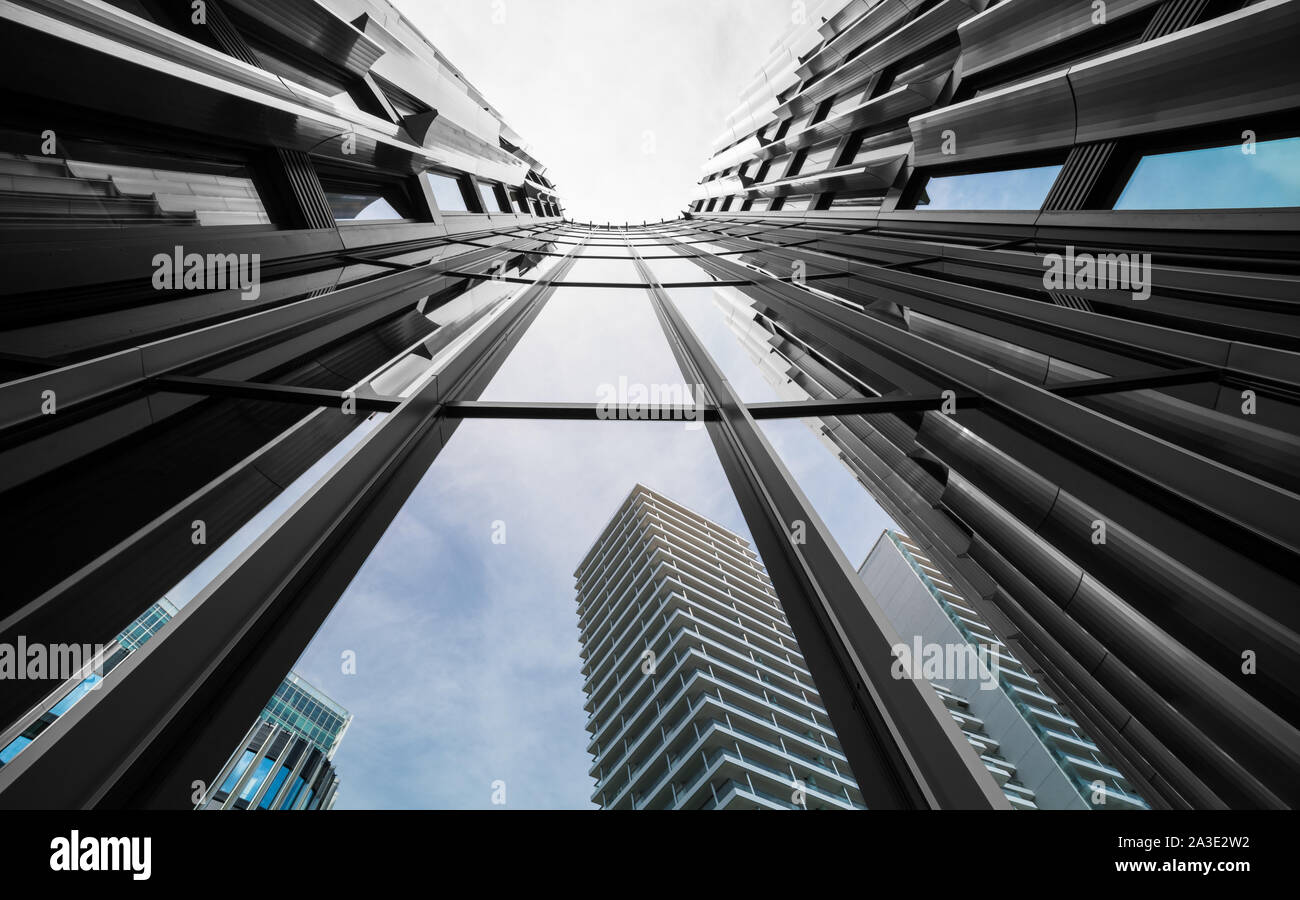 Modern high-rise building facade detail from below. Mirroring of ...