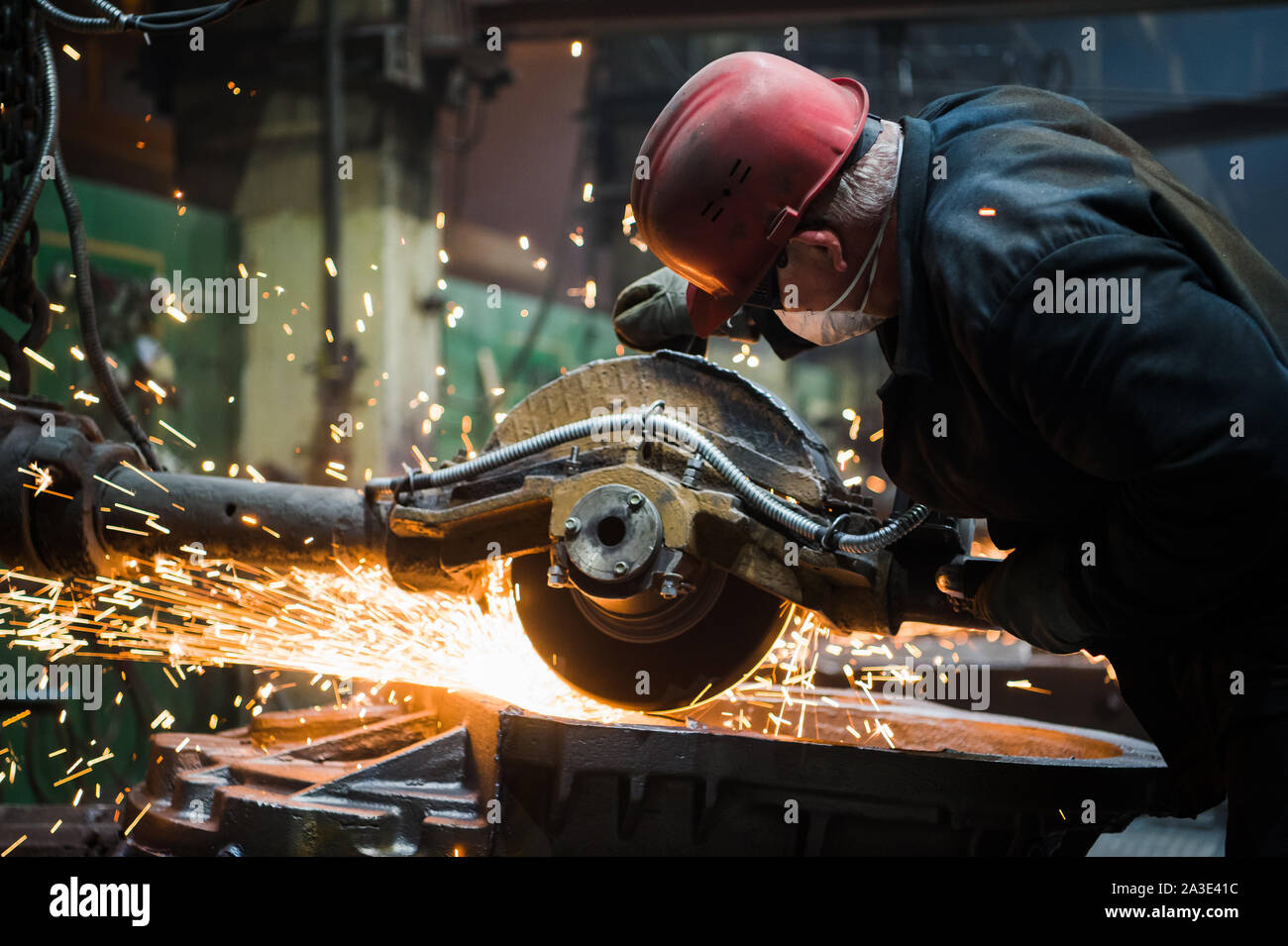 Worker grinding metal, metal grinding machine with sparks, metal sawing ...