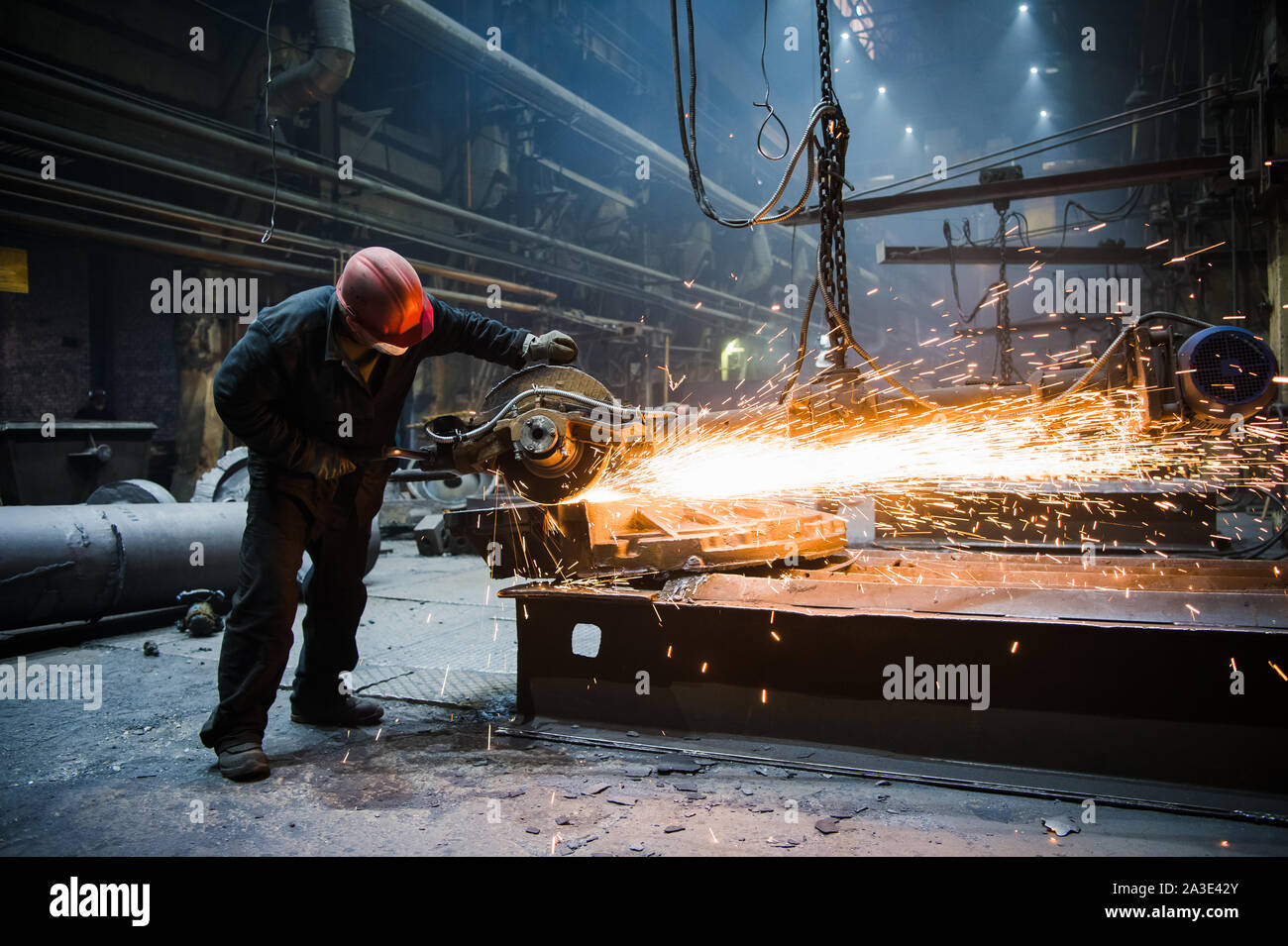 Worker grinding metal, metal grinding machine with sparks, metal sawing ...