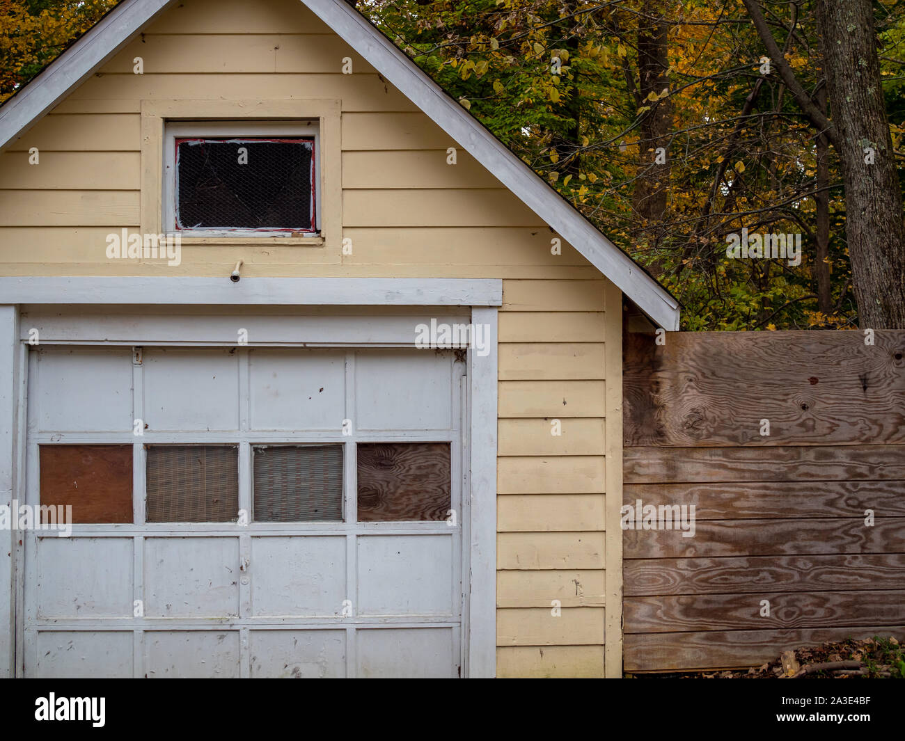 yellow garage shed in the forest in the fall in North America (USA ...