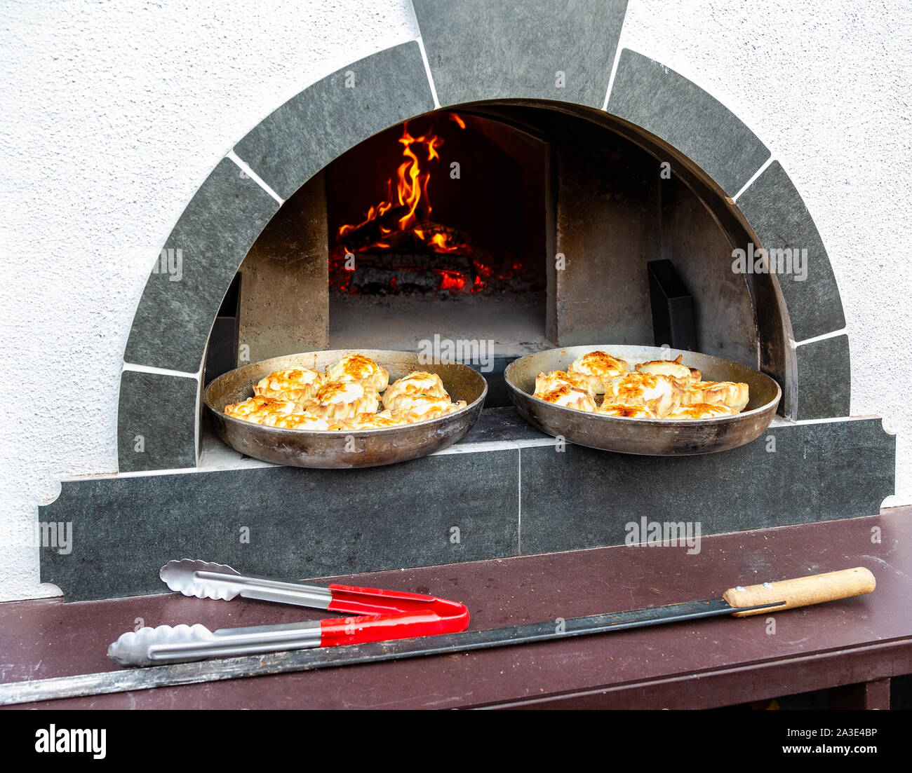 Cooking delicious traditional pies in a Russian oven Stock Photo - Alamy