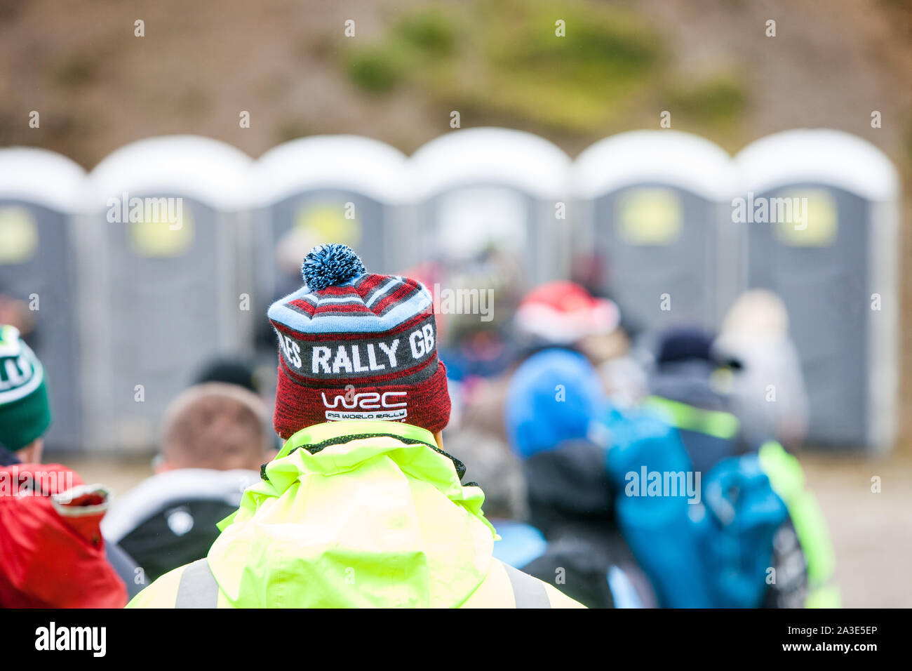 On,a,wet,rainy,day,Standing,waiting,in,line,Q,Queue,to,use,portable ...