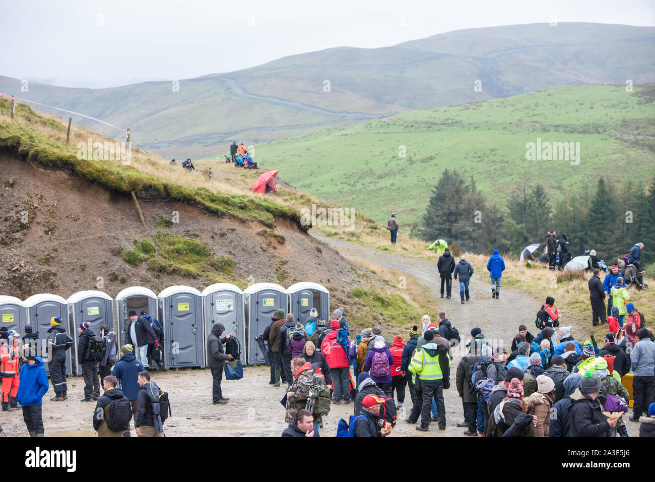 On,a,wet,rainy,day,Standing,waiting,in,line,Q,Queue,to,use,portable ...