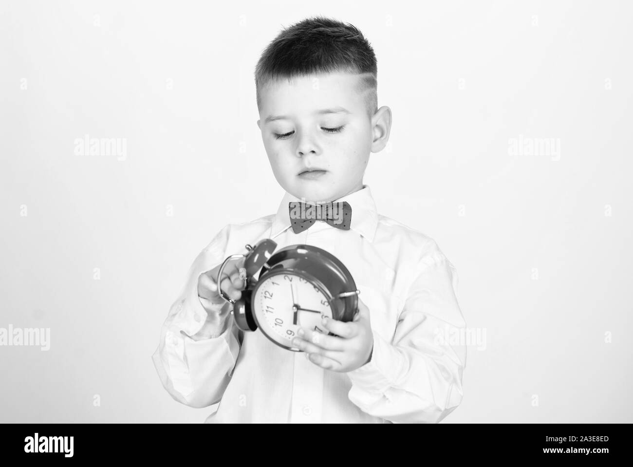 happy child with retro clock in bow tie. tuxedo kid. Happy childhood ...