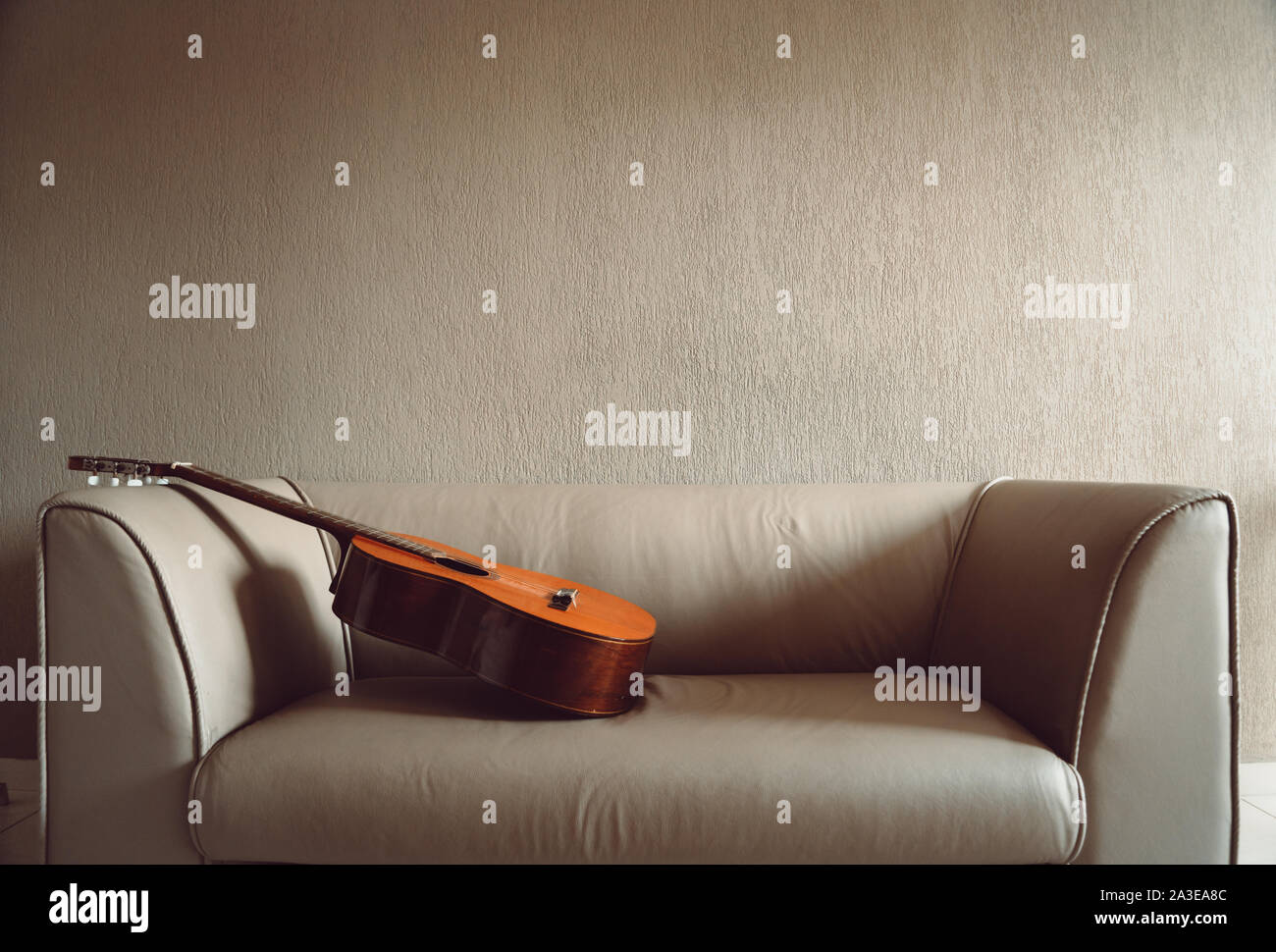 Isolated acoustic guitar on a couch with lights and shadows Stock Photo ...