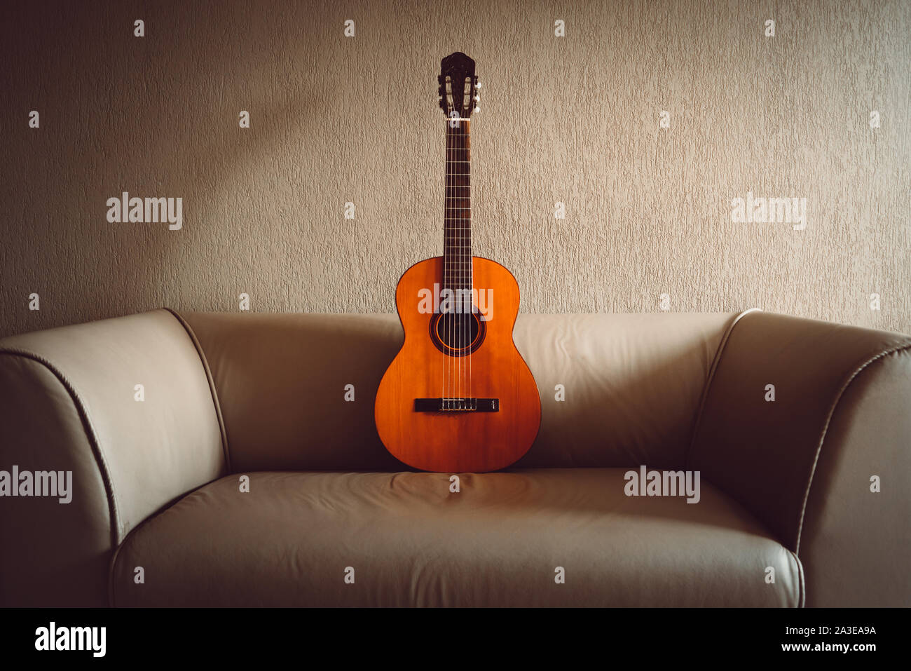 Isolated acoustic guitar on a couch with lights and shadows Stock Photo ...