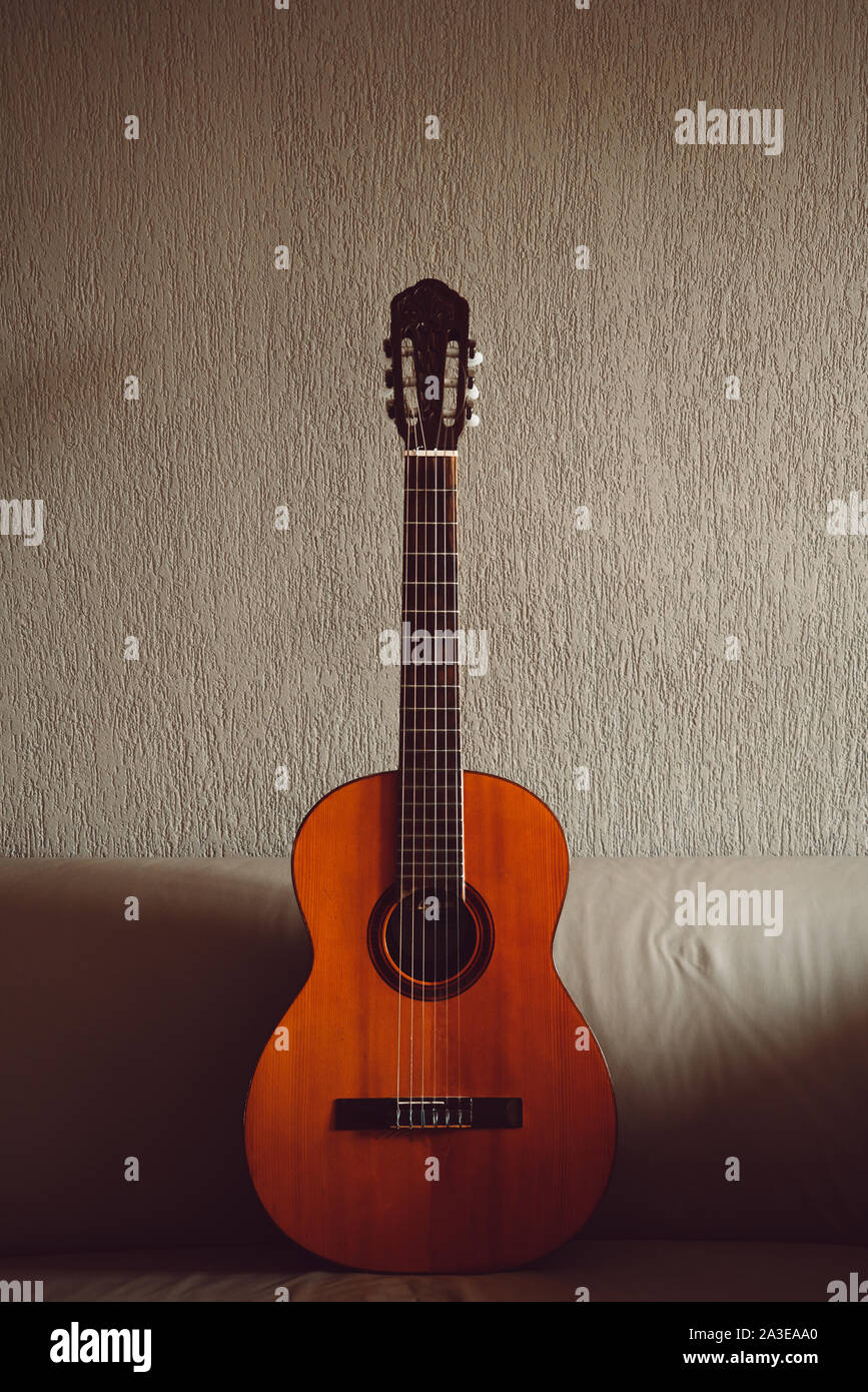 Isolated acoustic guitar on a couch with lights and shadows Stock Photo ...