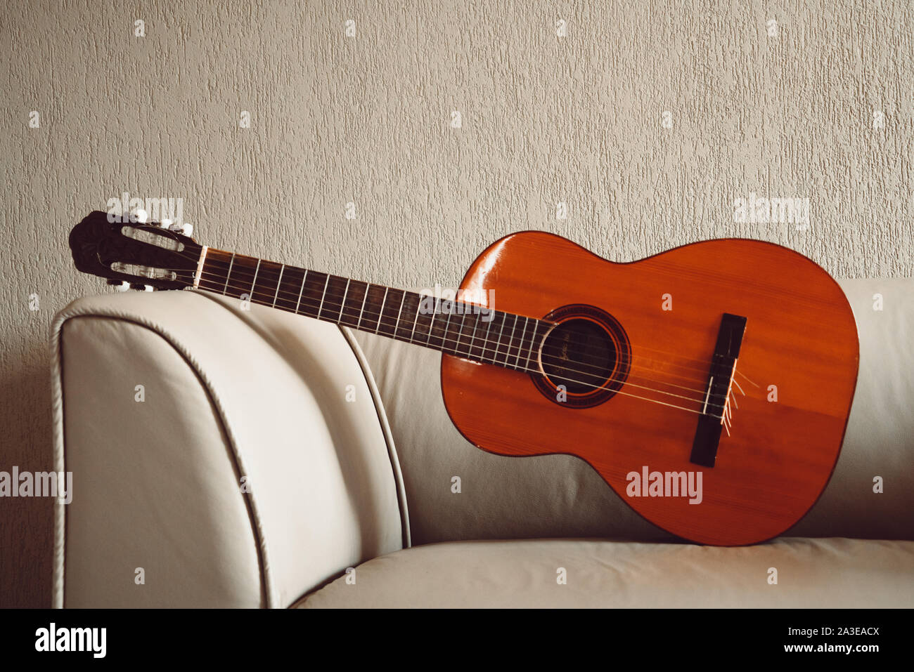 Isolated acoustic guitar on a couch with lights and shadows Stock Photo ...