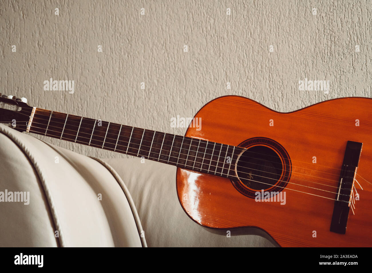 Isolated acoustic guitar on a couch with lights and shadows Stock Photo ...
