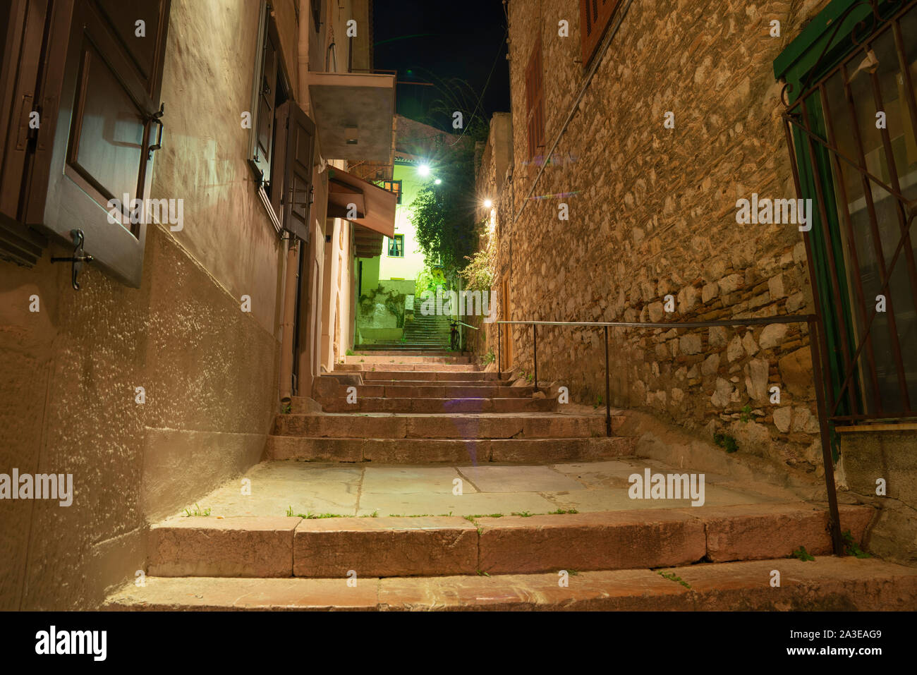 Night scene between building with steps leading upwards to light Stock ...