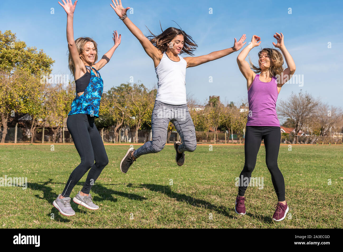 Three young people jumping hi-res stock photography and images - Alamy