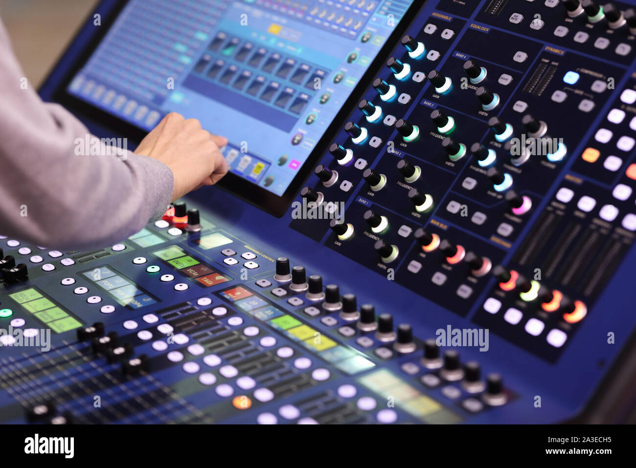 Operator working with professional stage lighting control console ...