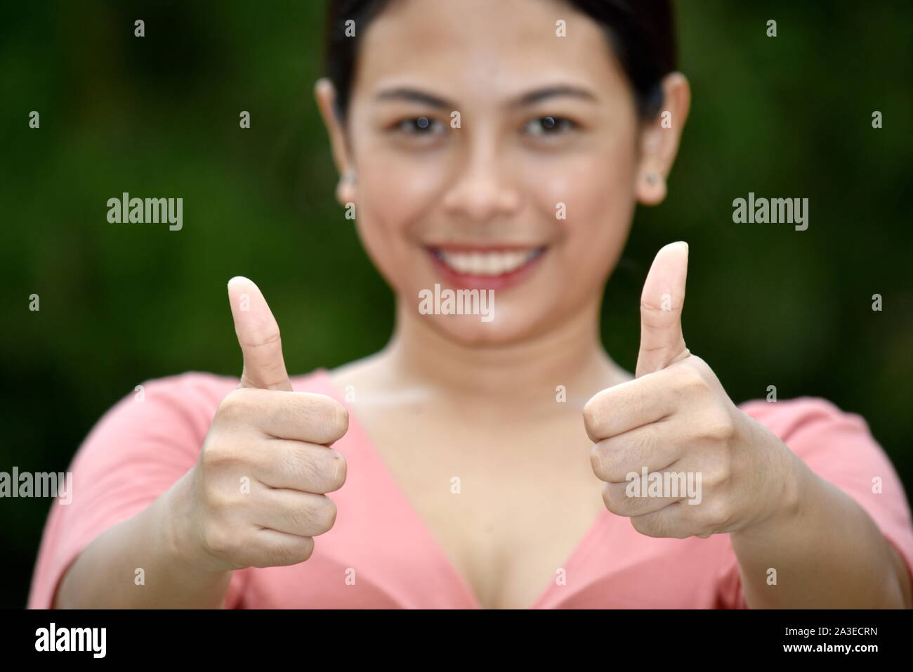 An Attractive Female With Thumbs Up Stock Photo - Alamy